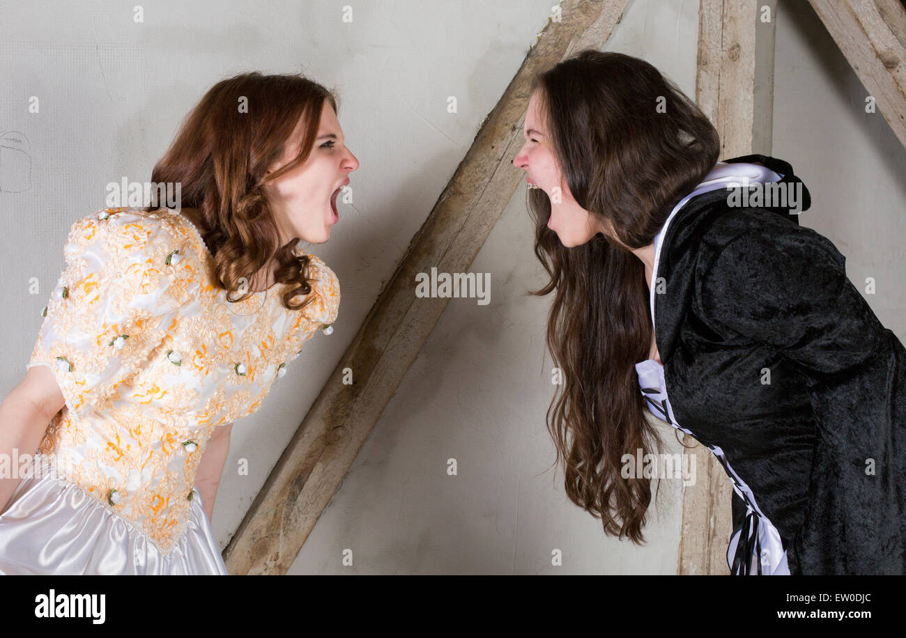 young women dressed as princess and witch screaming at each other Stock ...