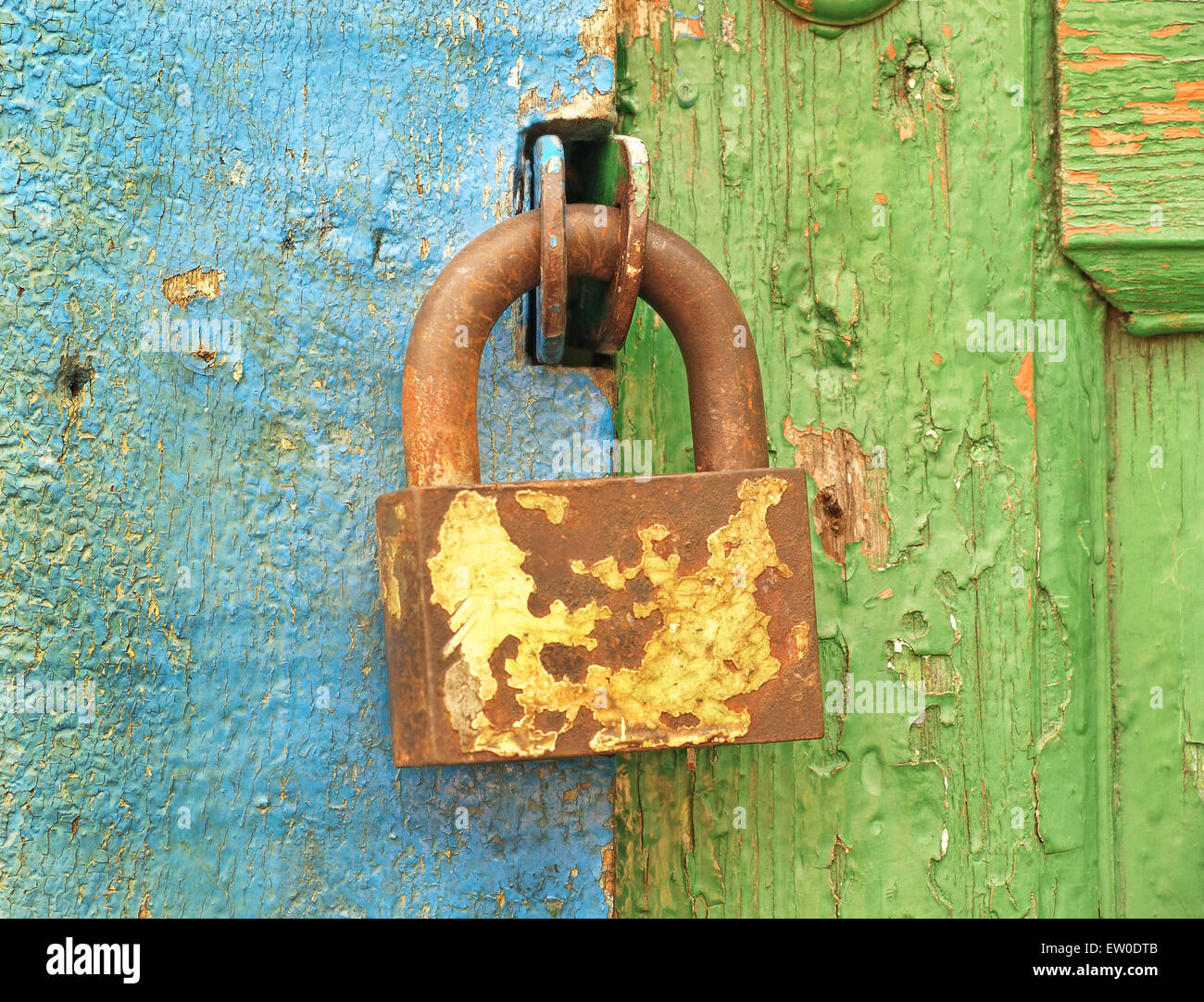 Old metal lock on a color wooden door taken closeup Stock Photo - Alamy