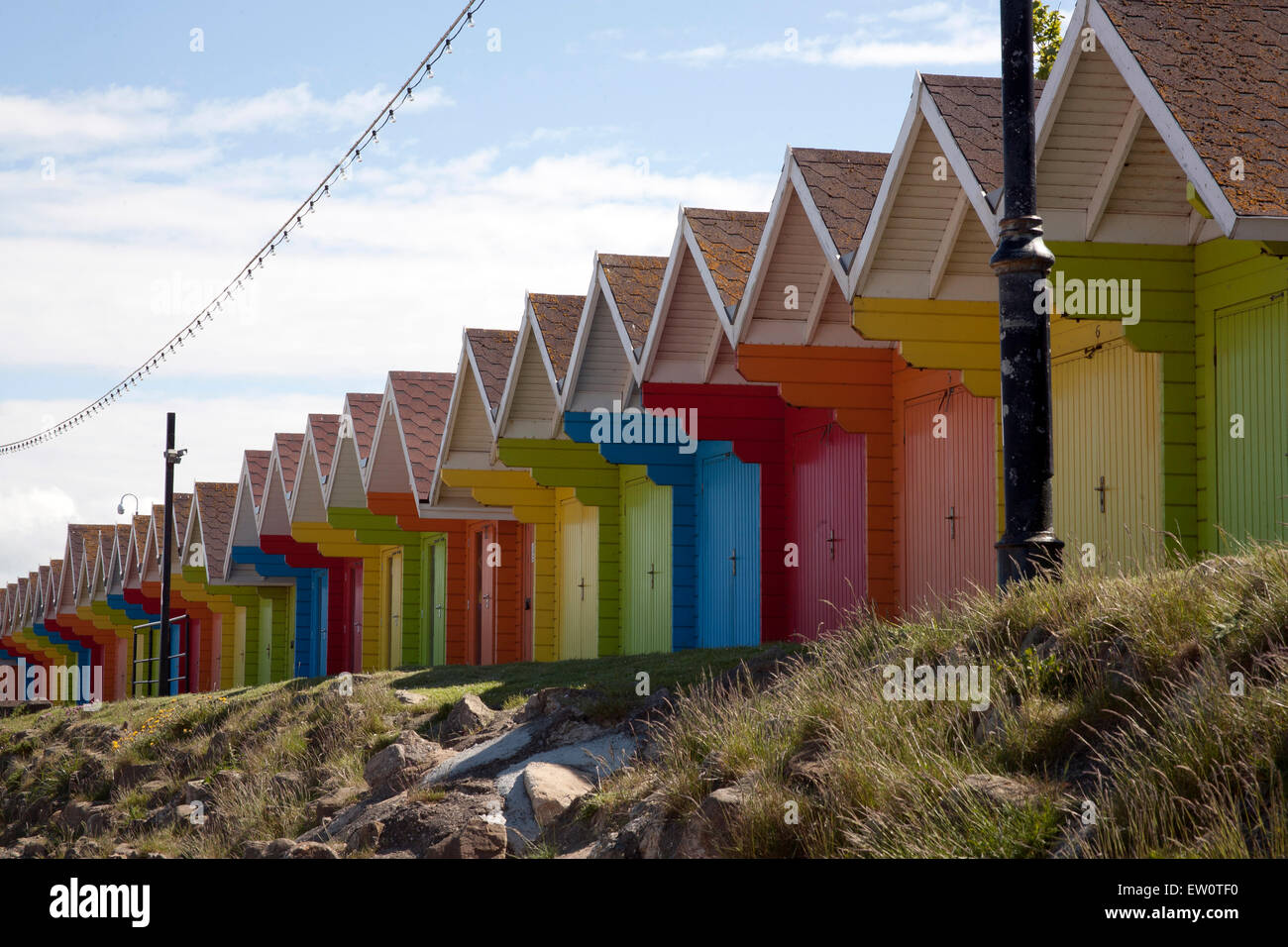 Row of brightly painted beach huts along the seafront, North Bay ...