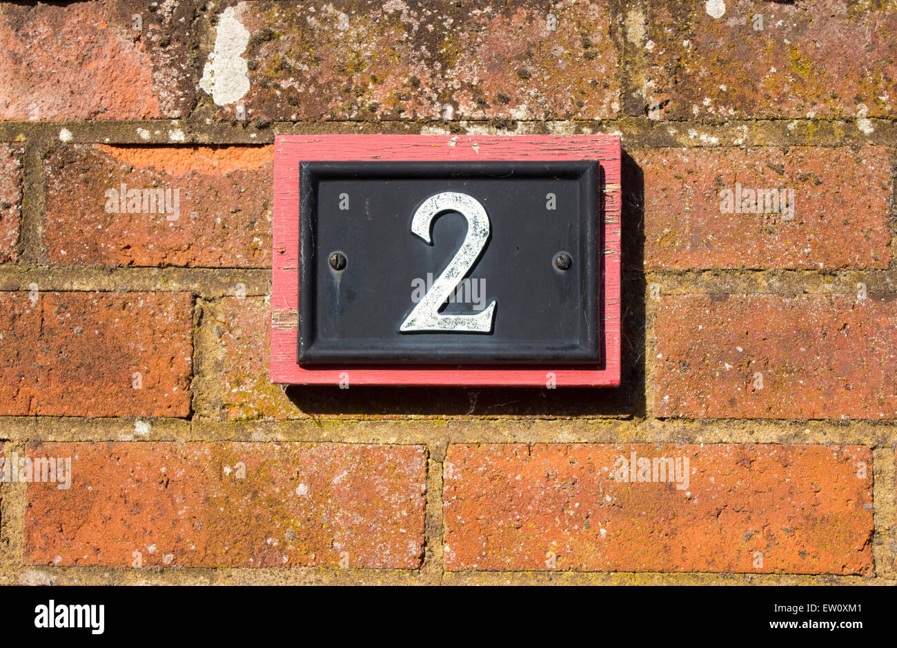 House number two sign on a red brick wall Stock Photo - Alamy