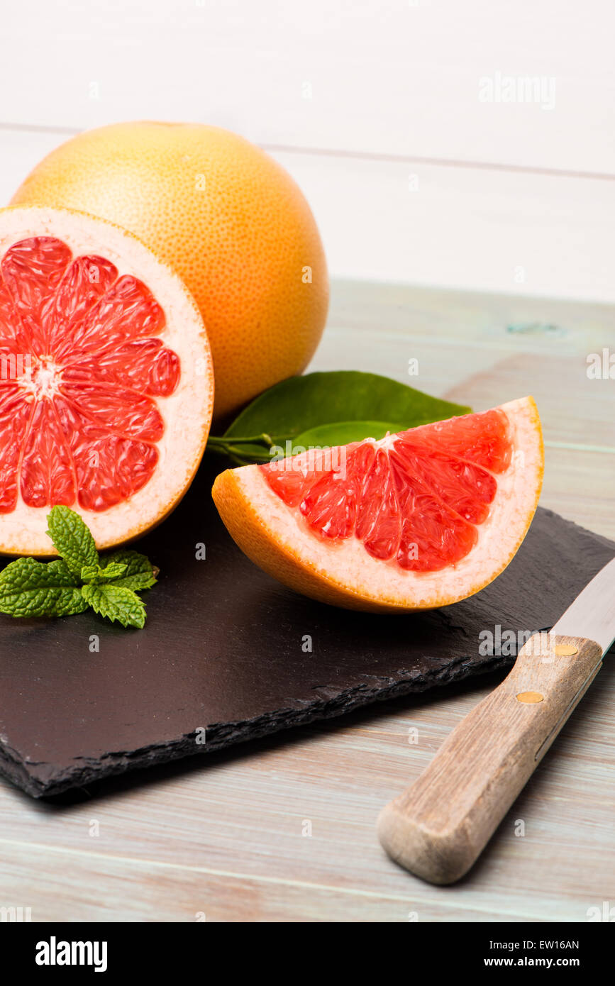 Ripe grapefruit close-up on wooden table background Stock Photo - Alamy