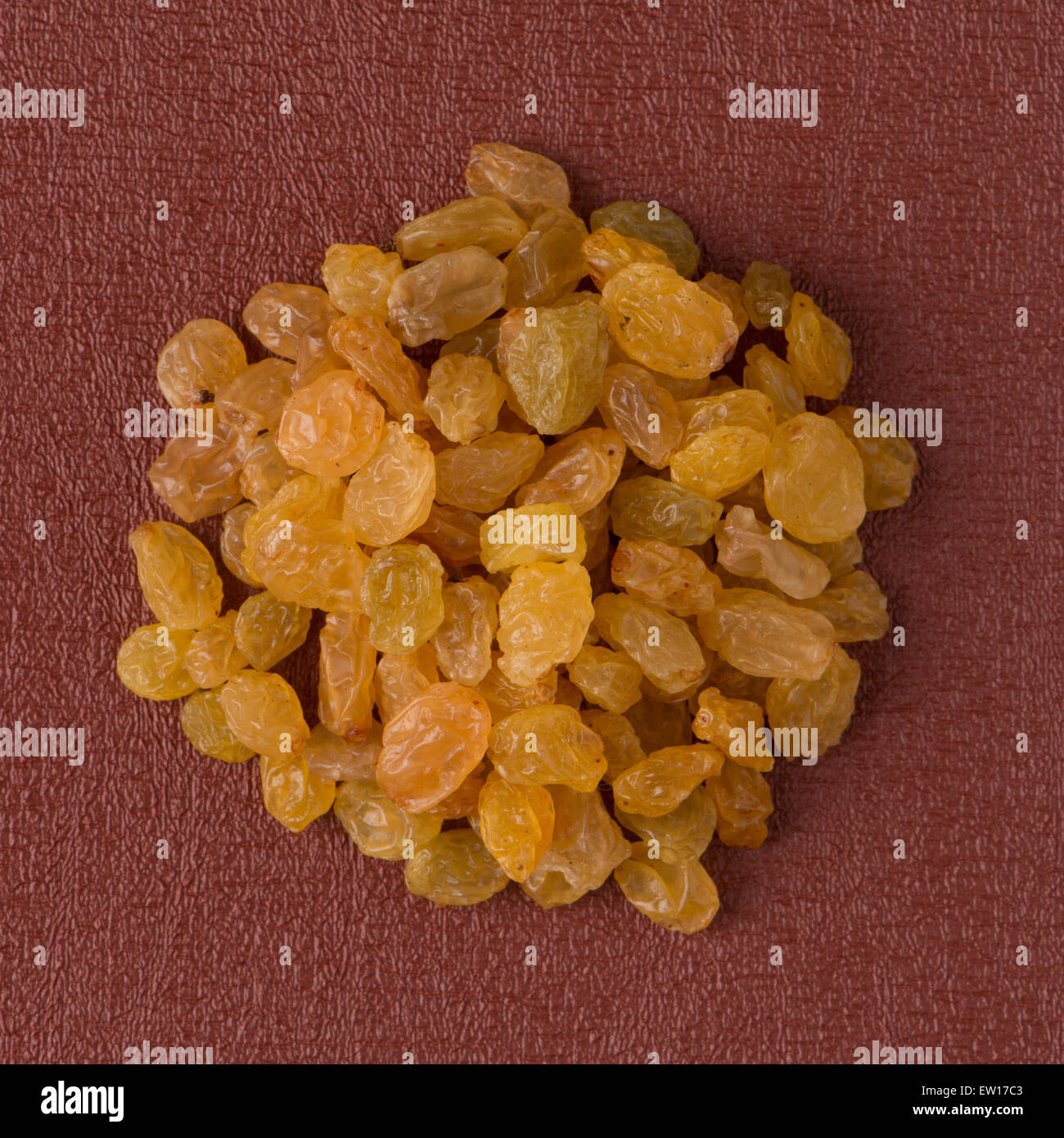 Top view of circle of golden raisins against red vinyl background Stock Photo - Alamy