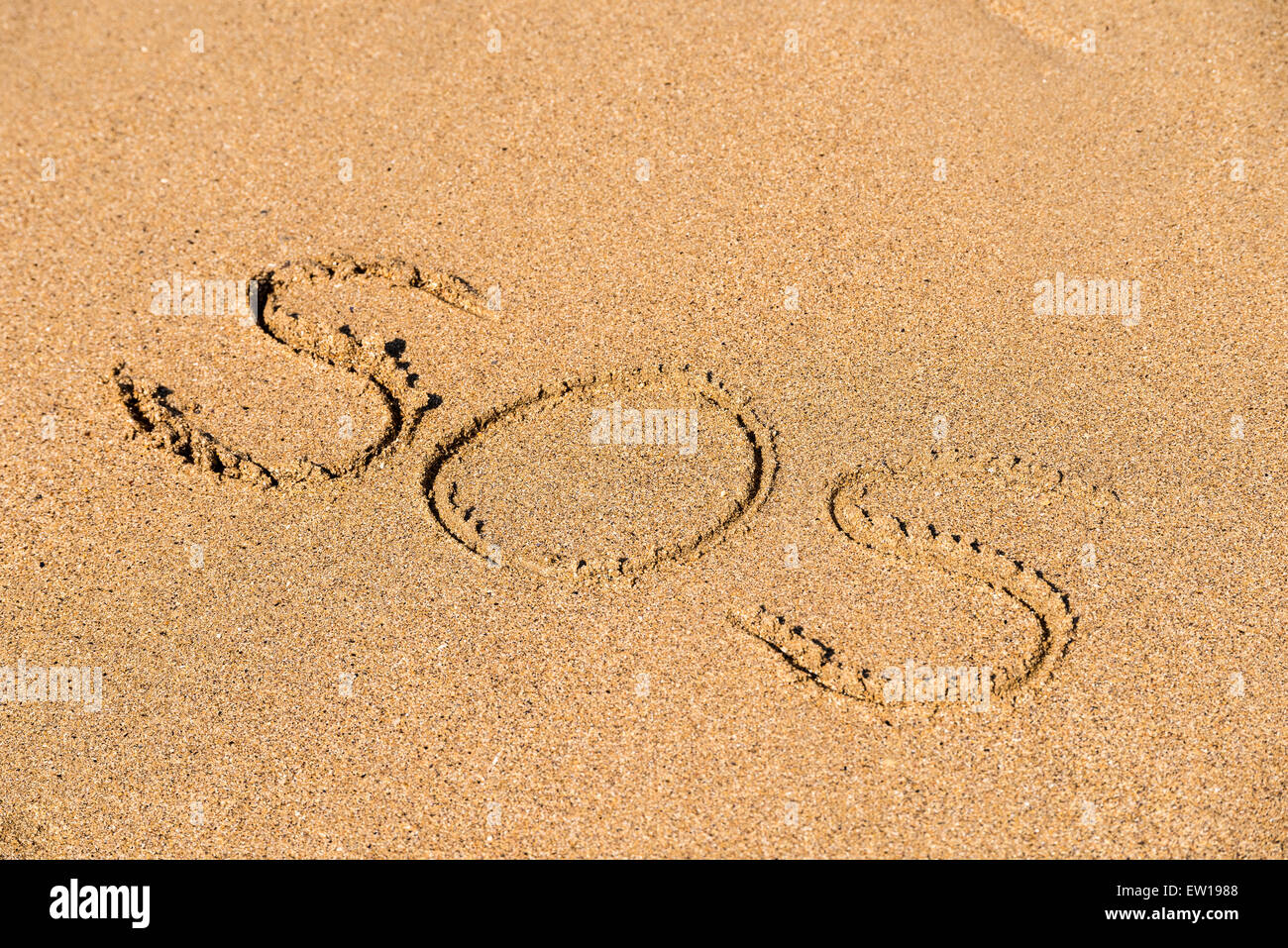Help Sign Drawn On Beach Sand Stock Photo - Alamy