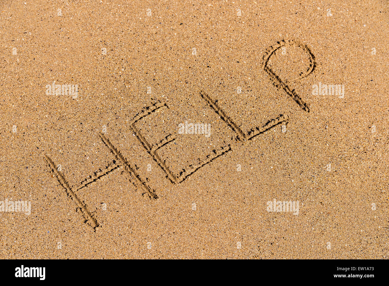 Help Sign Drawn On Beach Sand Stock Photo - Alamy