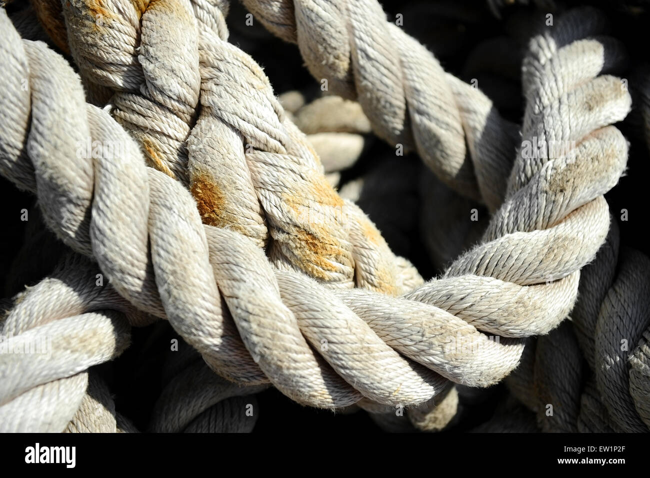 Industrial detail with a heap of old maritime sea ropes Stock Photo - Alamy