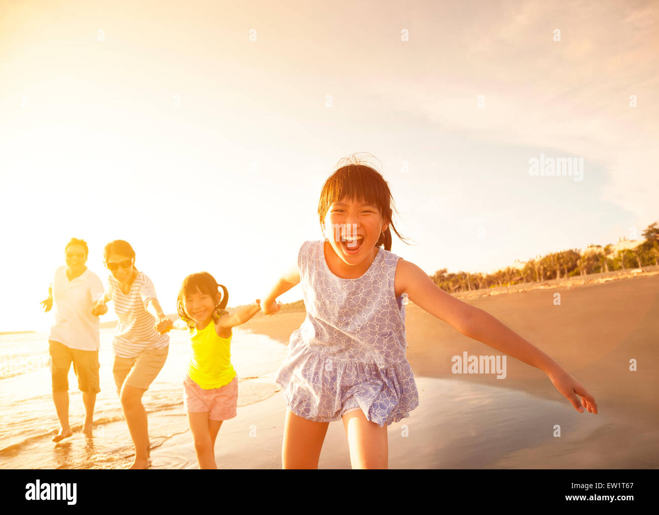 Happy family running on beach hi-res stock photography and images - Alamy
