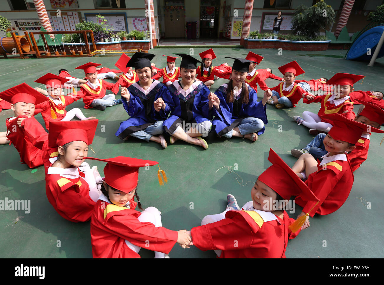 Chongqing, China. 16th June, 2015. Children pose for a graduation photo ...