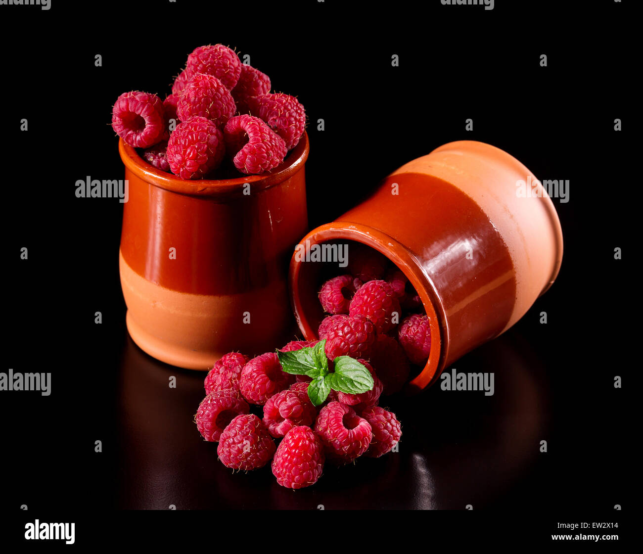 Harvest delicious raspberries in a ceramic pot Stock Photo - Alamy