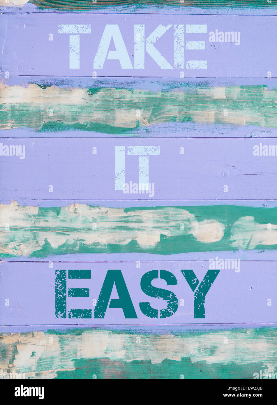Concept image of TAKE IT EASY motivational quote written on vintage ...
