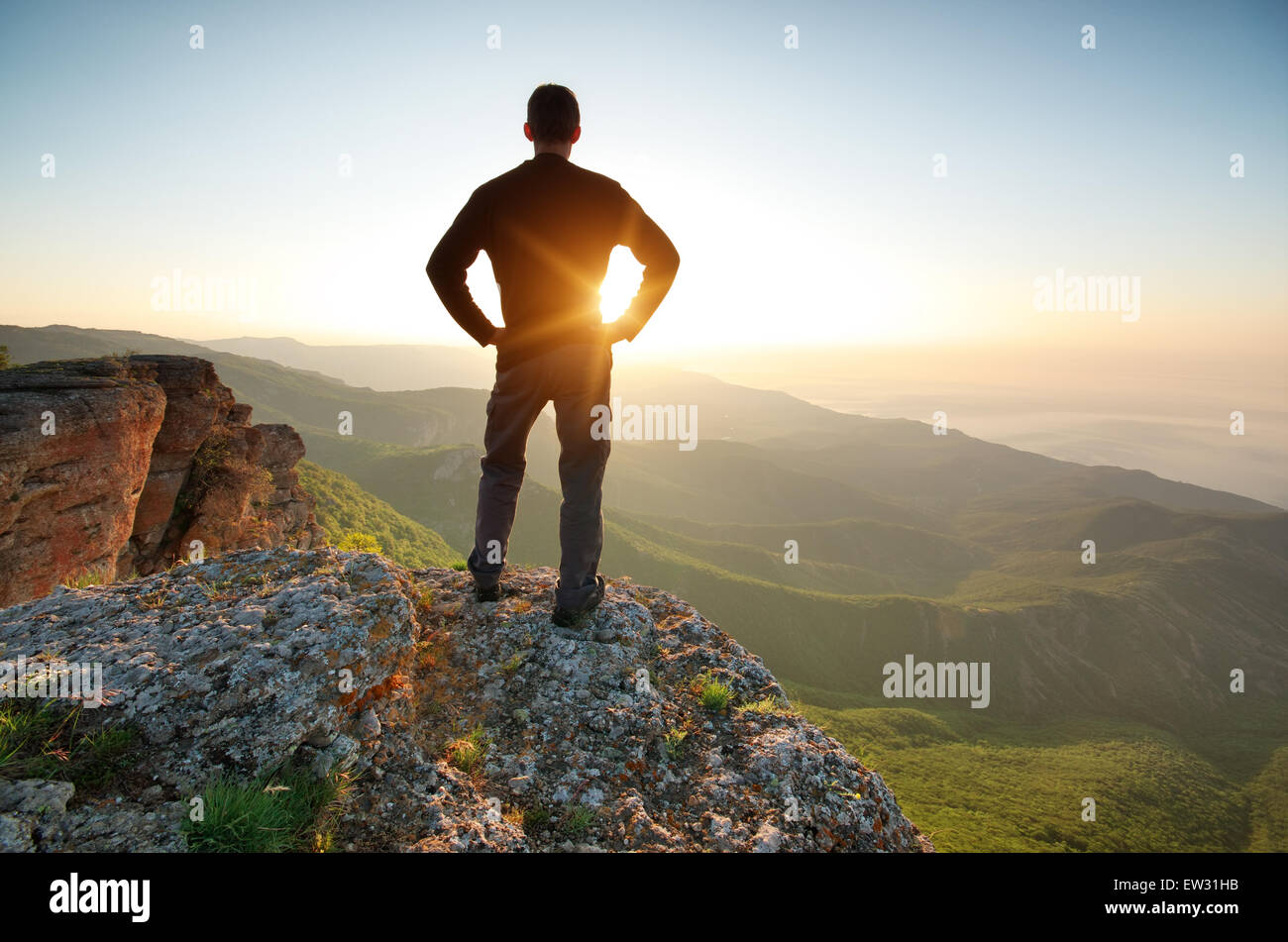 Man on top of mountain. Conceptual scene Stock Photo - Alamy