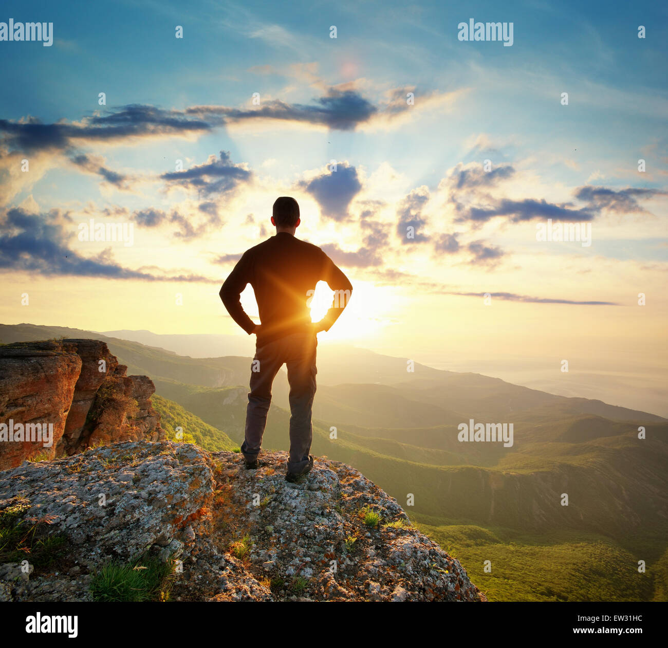 Man on top of mountain. Conceptual scene Stock Photo - Alamy