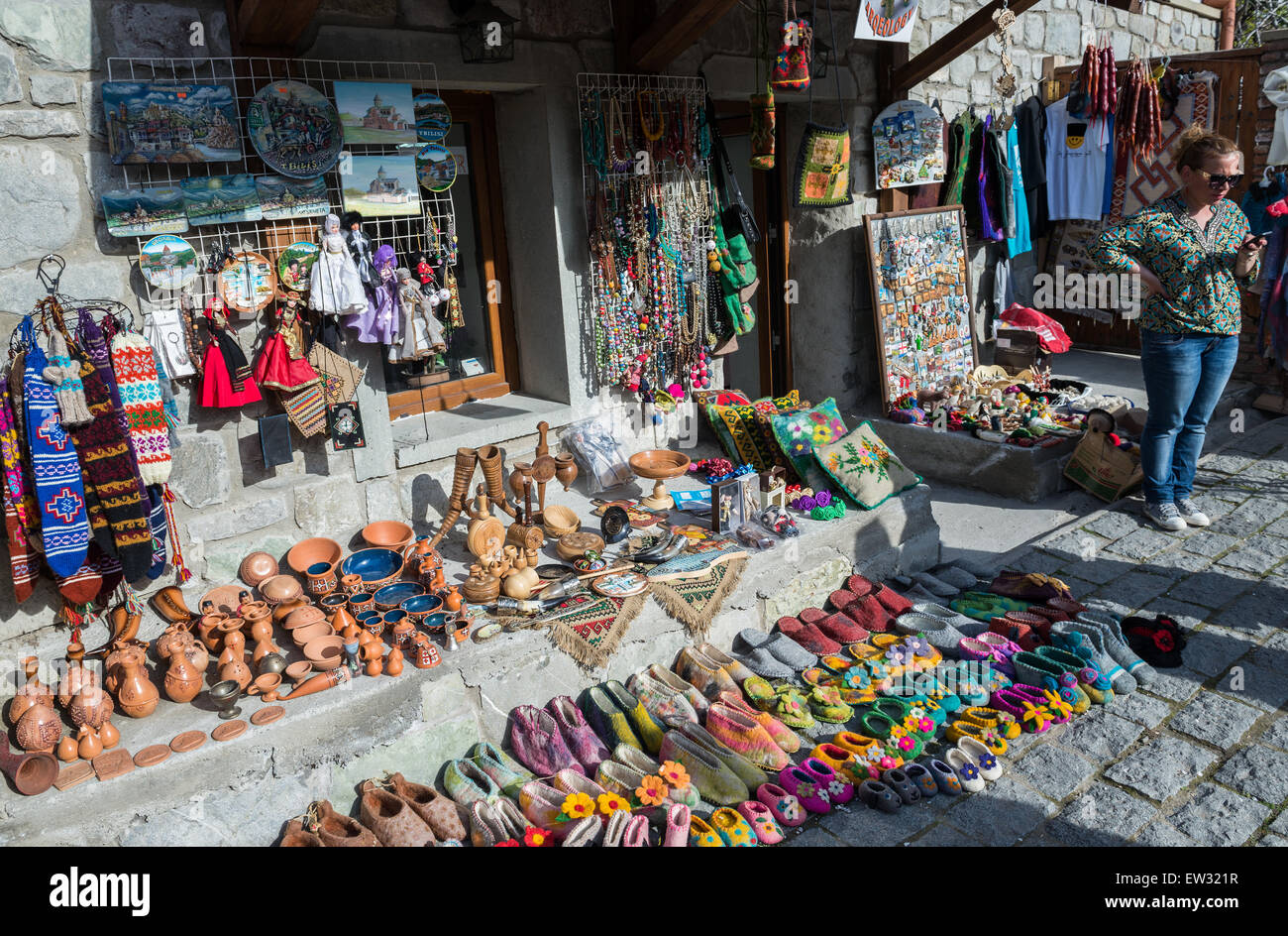 Woman selling wool and clay products in UNESCO historical town of ...