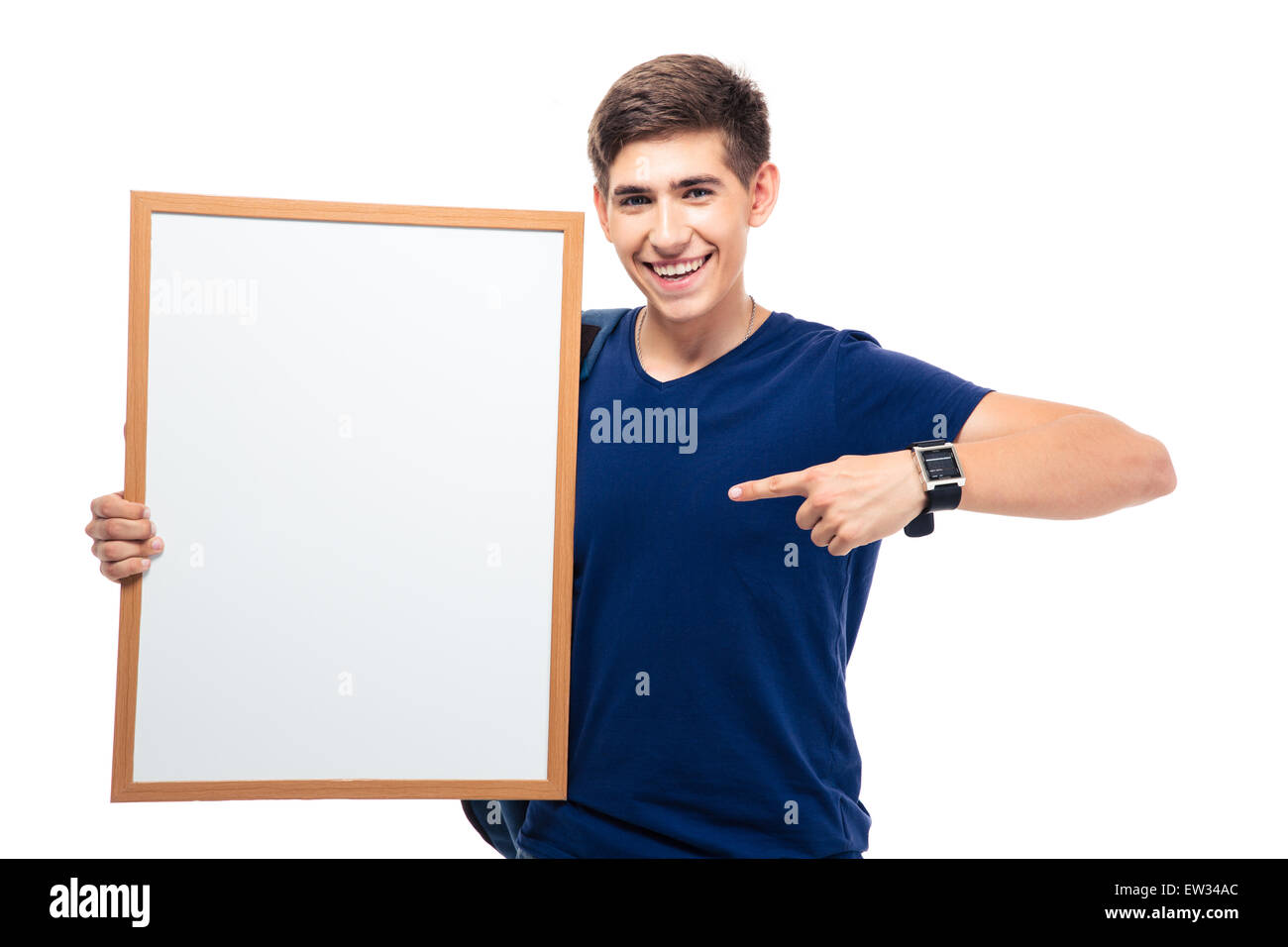 Smiling male student pointing finger on blank board isolated on a white ...