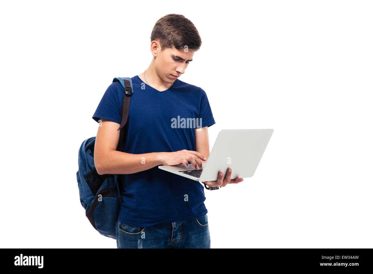 Casual man standing and using laptop isolated on a white background ...