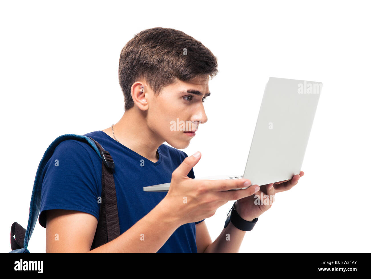 Male student standing and using laptop isolated on a white background ...