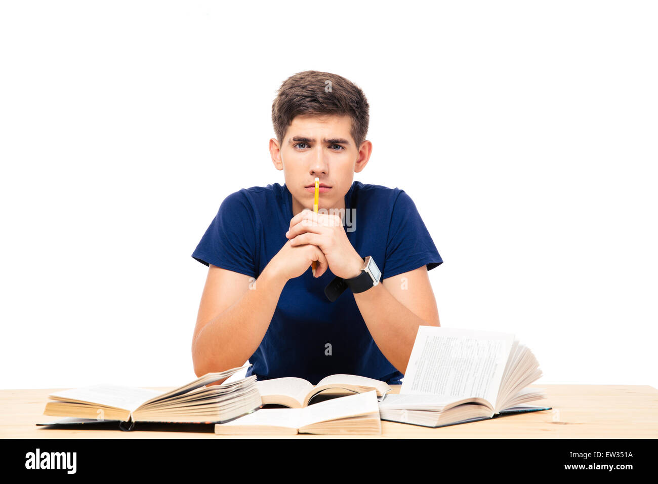 Male student sitting at the table with books isolated on a white ...