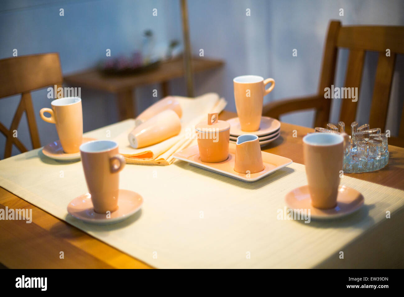 wooden table with cups and plates Stock Photo - Alamy