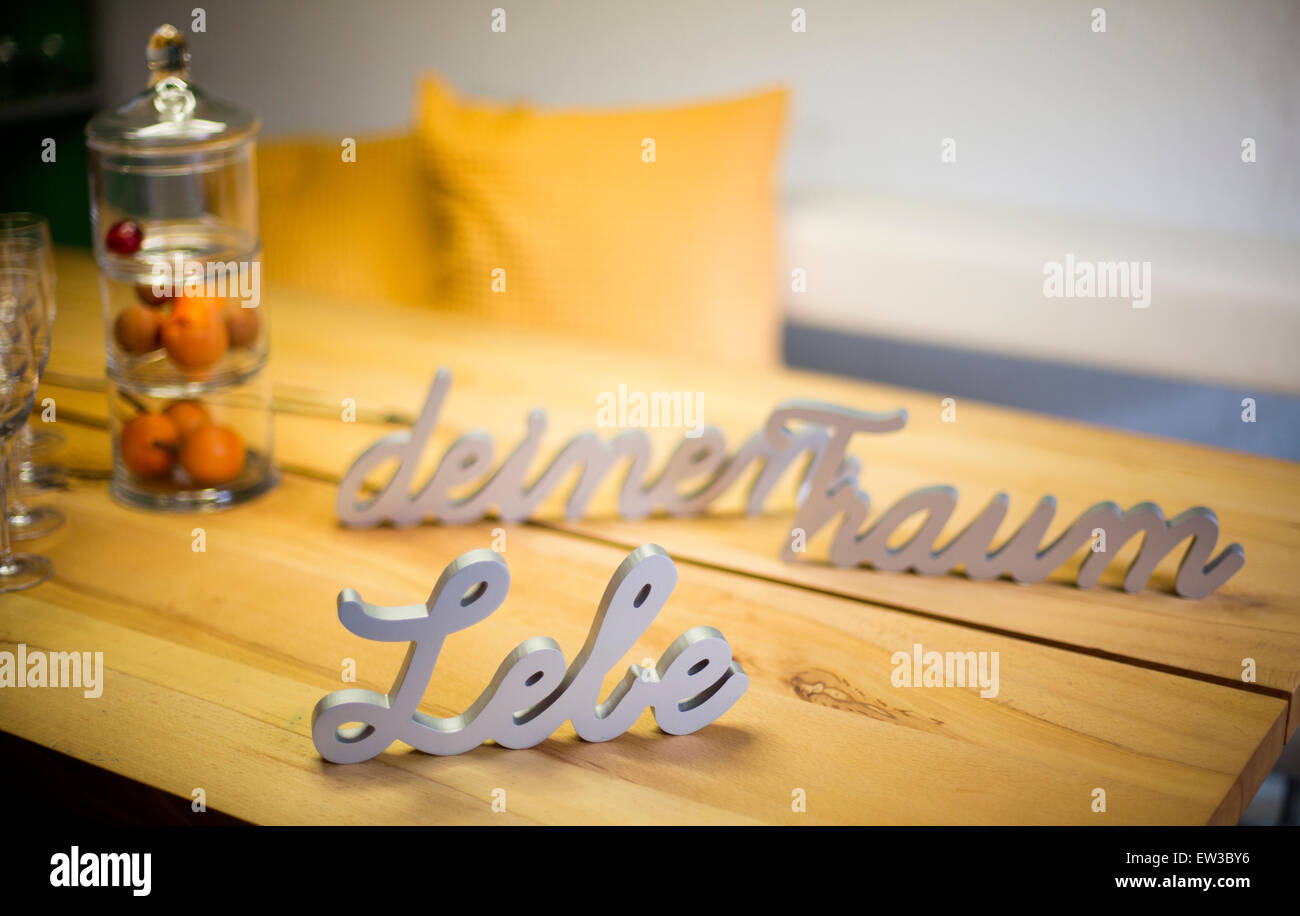 german quote "Lebe Deinen Traum" in wooden letters on wooden table in ...