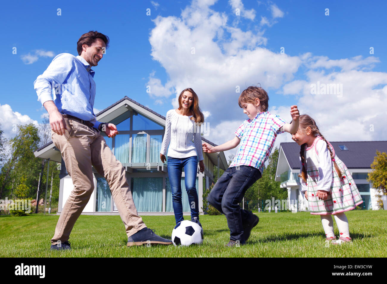 family playing football Stock Photo - Alamy