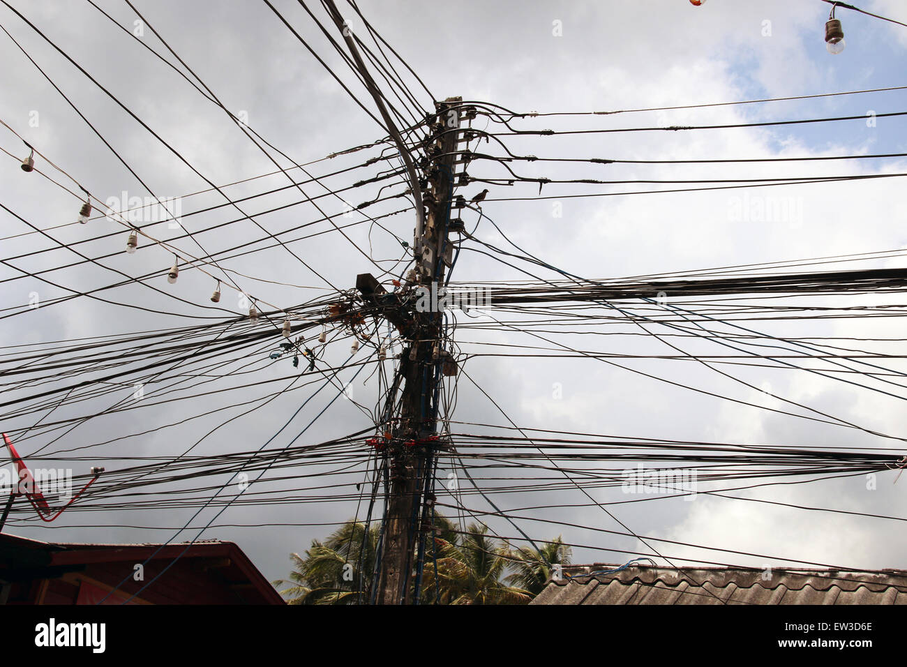 tangled web of cables connected to power supply on wooden pole Stock ...