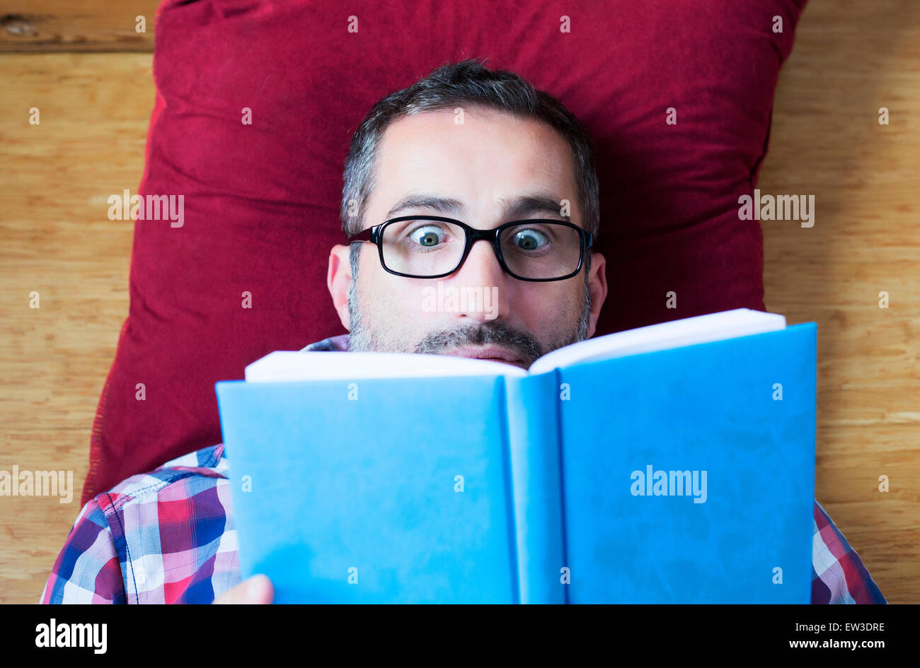 man with glasses reading a book Stock Photo - Alamy