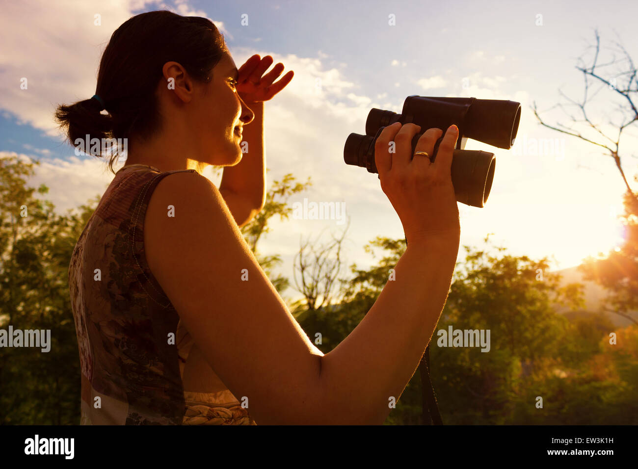 Young woman with binoculars in nature Stock Photo - Alamy