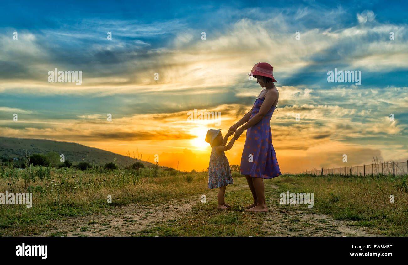 happy mother and daughter having fun at sunset Stock Photo - Alamy
