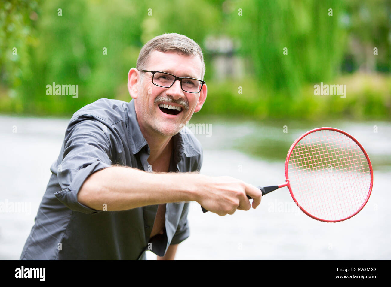 man is playing badminton by the water Stock Photo - Alamy