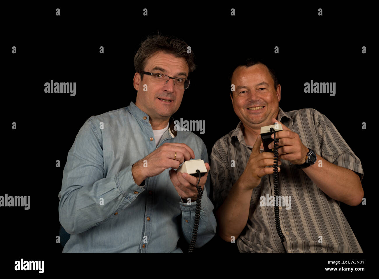 Two guys in their 40s having fun with an old video game Stock Photo - Alamy