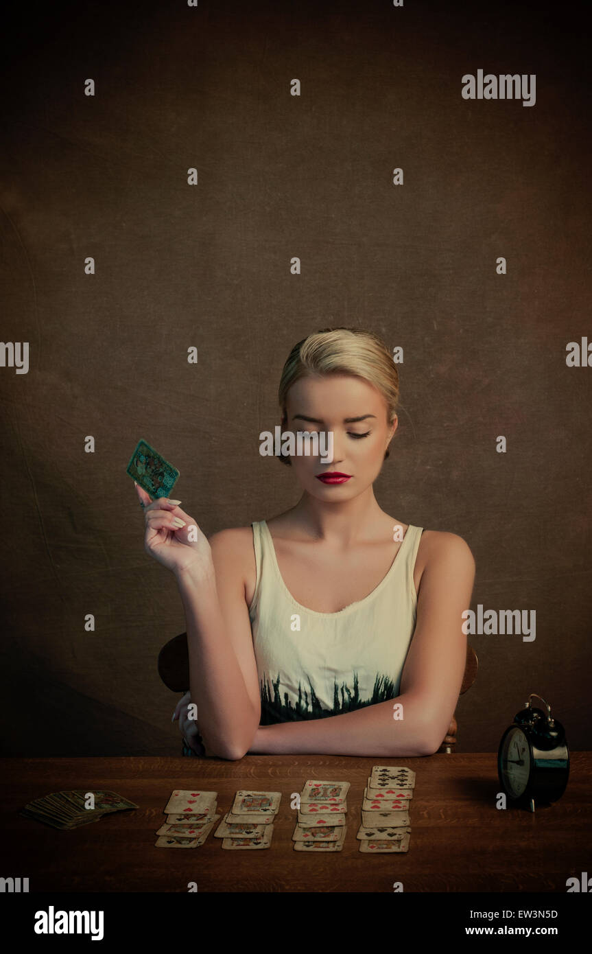 Beautiful young woman playing cards Stock Photo - Alamy