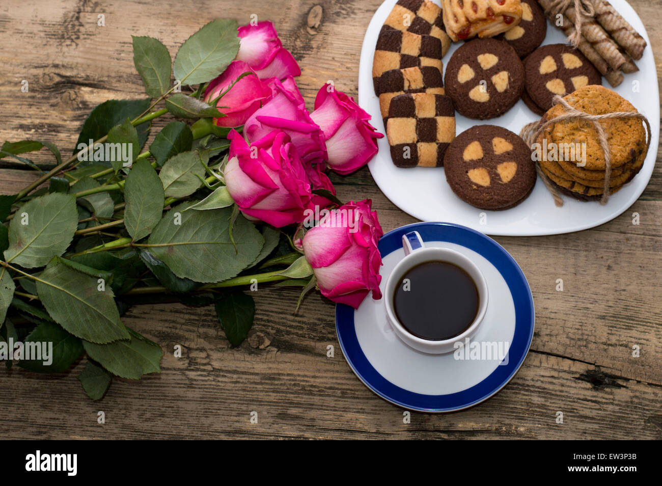 pink roses, coffee and cookies top view Stock Photo - Alamy