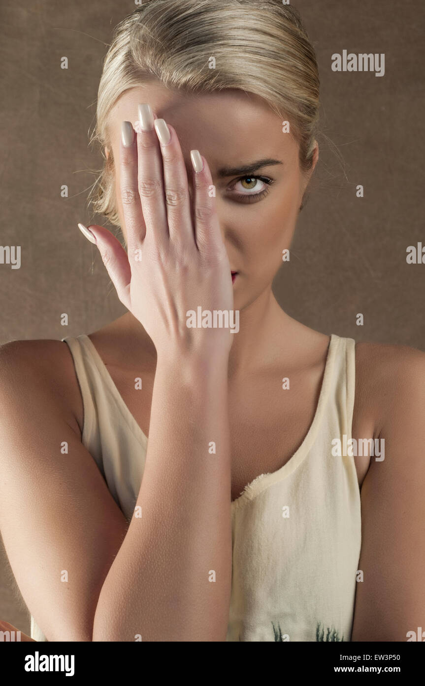 Young woman hiding face with hand Stock Photo - Alamy