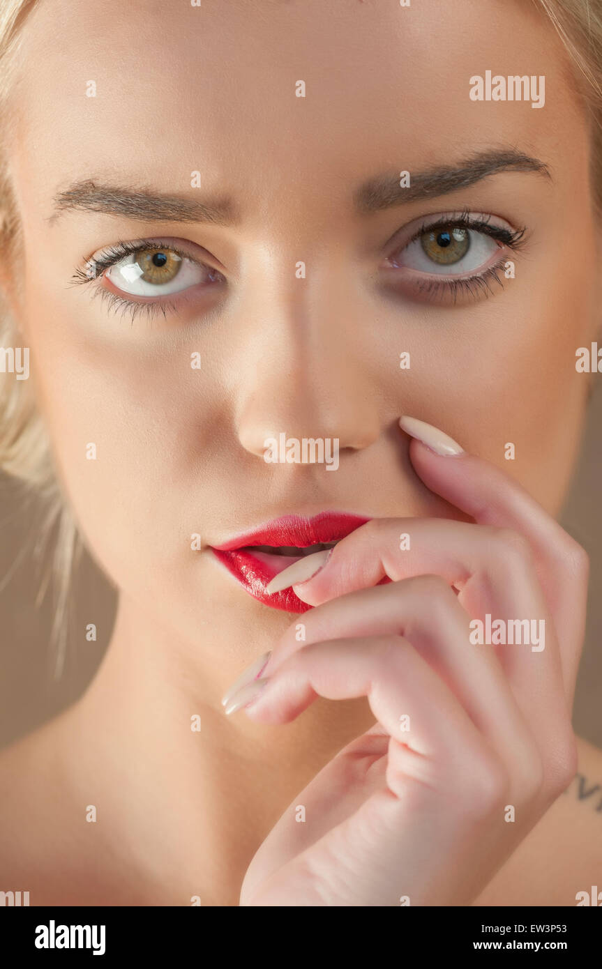 Beautiful young woman hand touching lips Stock Photo - Alamy
