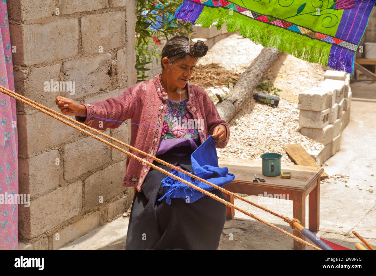 A traditional Tzotzil woman sews clothes and cloths Stock Photo - Alamy