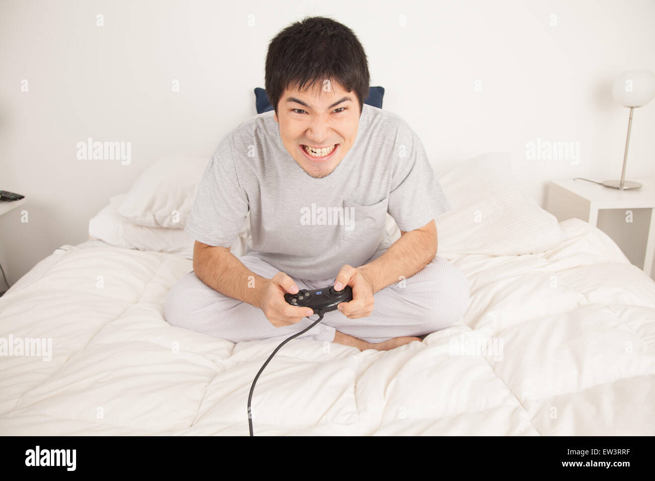 Young man in his bedroom Stock Photo - Alamy