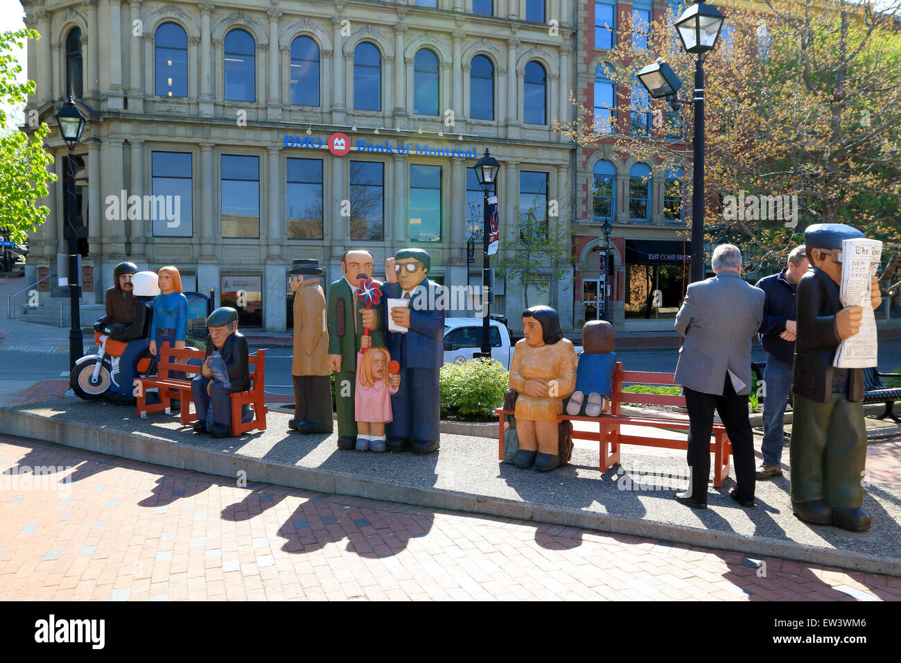 Street art sculpture "People Waiting" by John Hooper. Bus stop queue ...