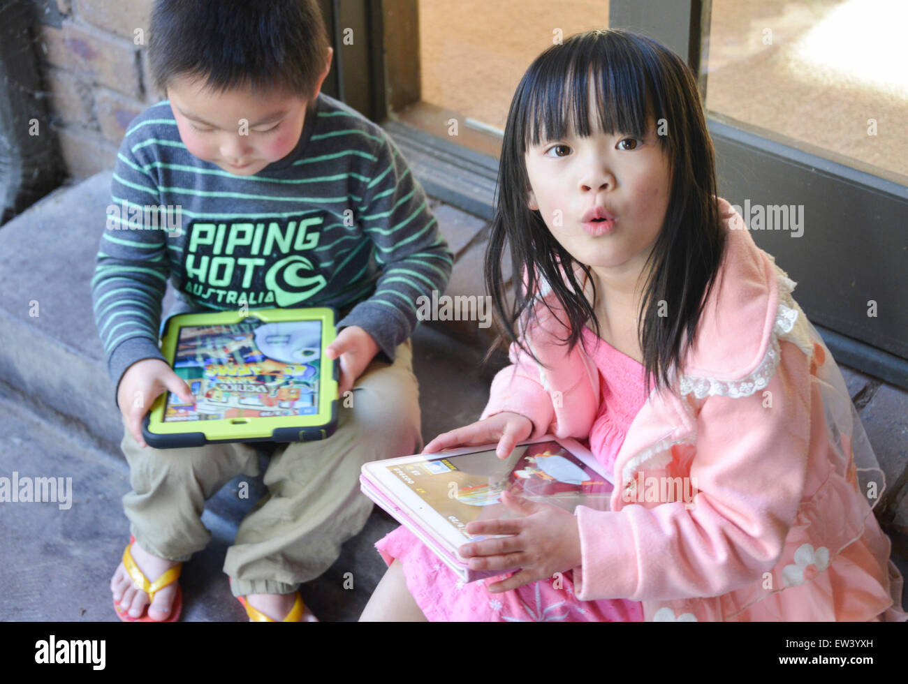 chinese children girl and boy 5 and 6 years playing computer game on ...