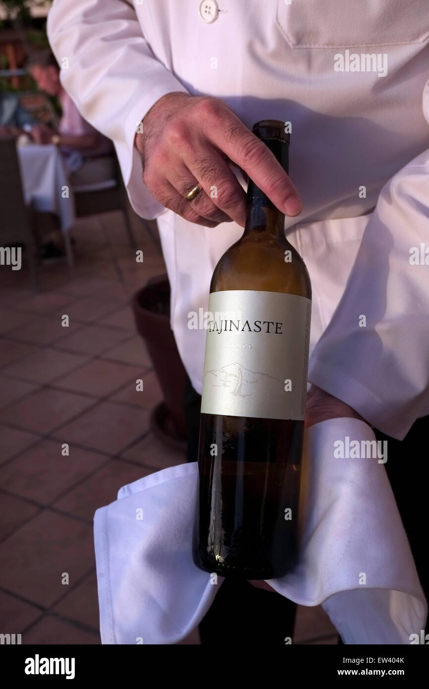 A waiter shows a local white wine from Tajinaste winery at the terrace ...