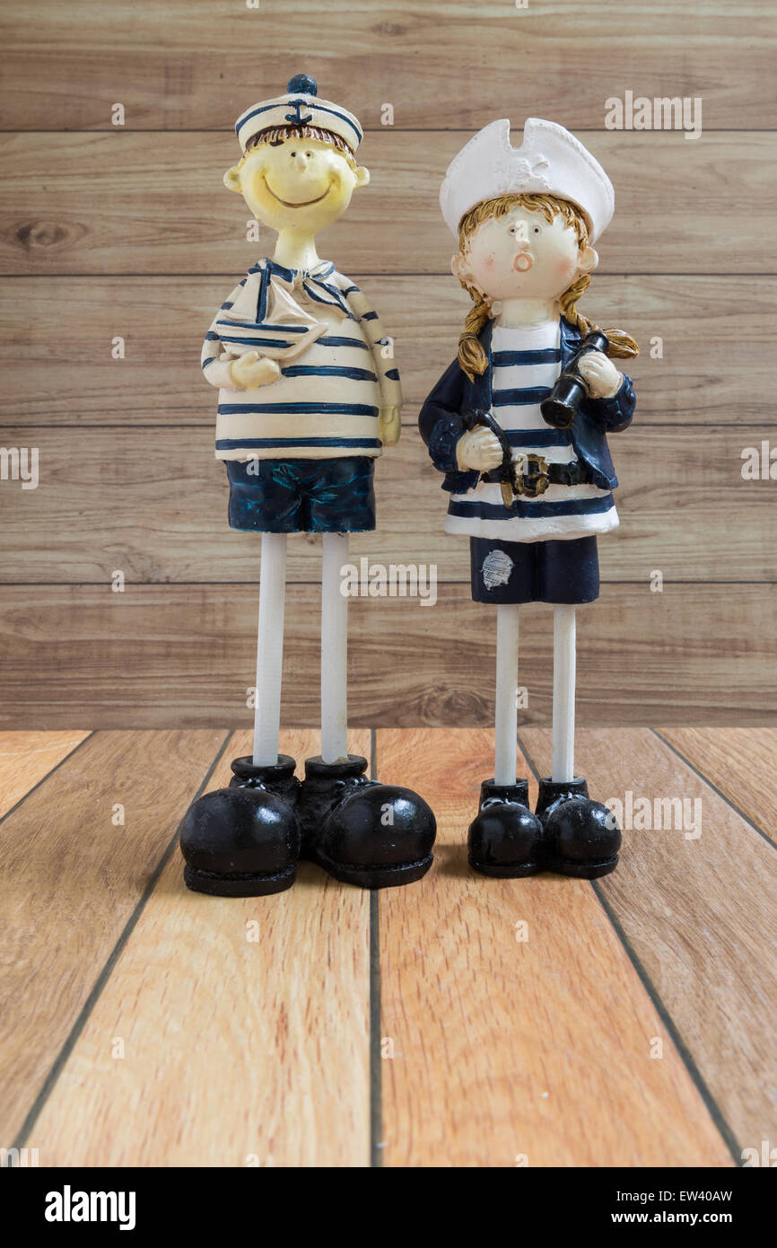 Dolls of a sailor family on wood background Stock Photo - Alamy