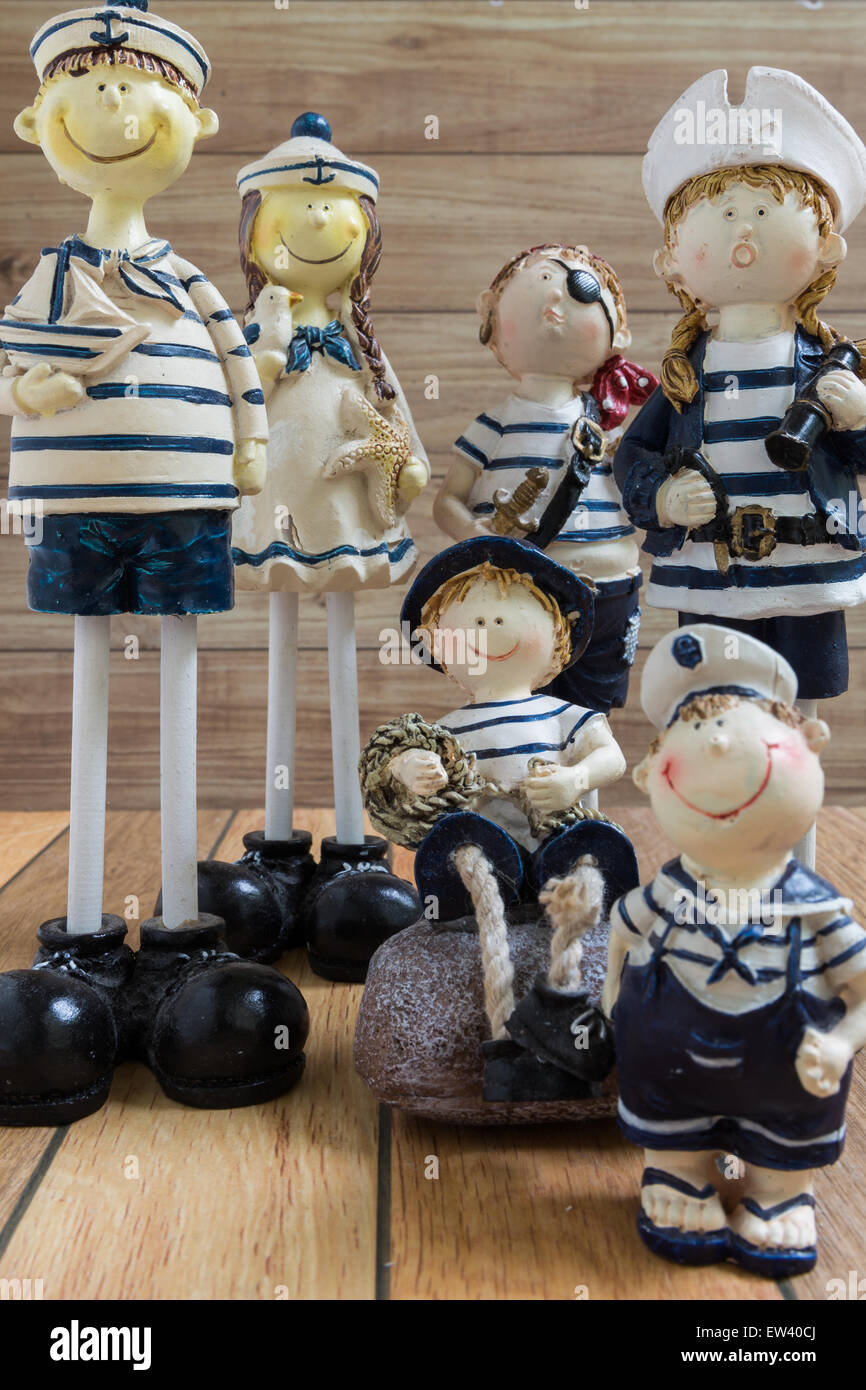 Dolls of a sailor family on wood background Stock Photo - Alamy