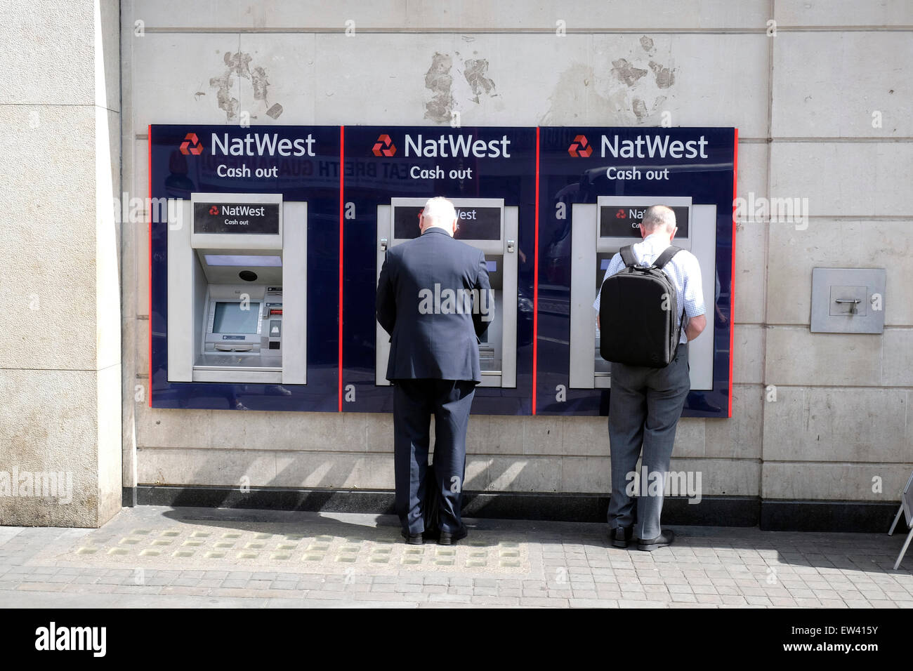 Two men withdrawing money fro a cash machine hi-res stock photography ...