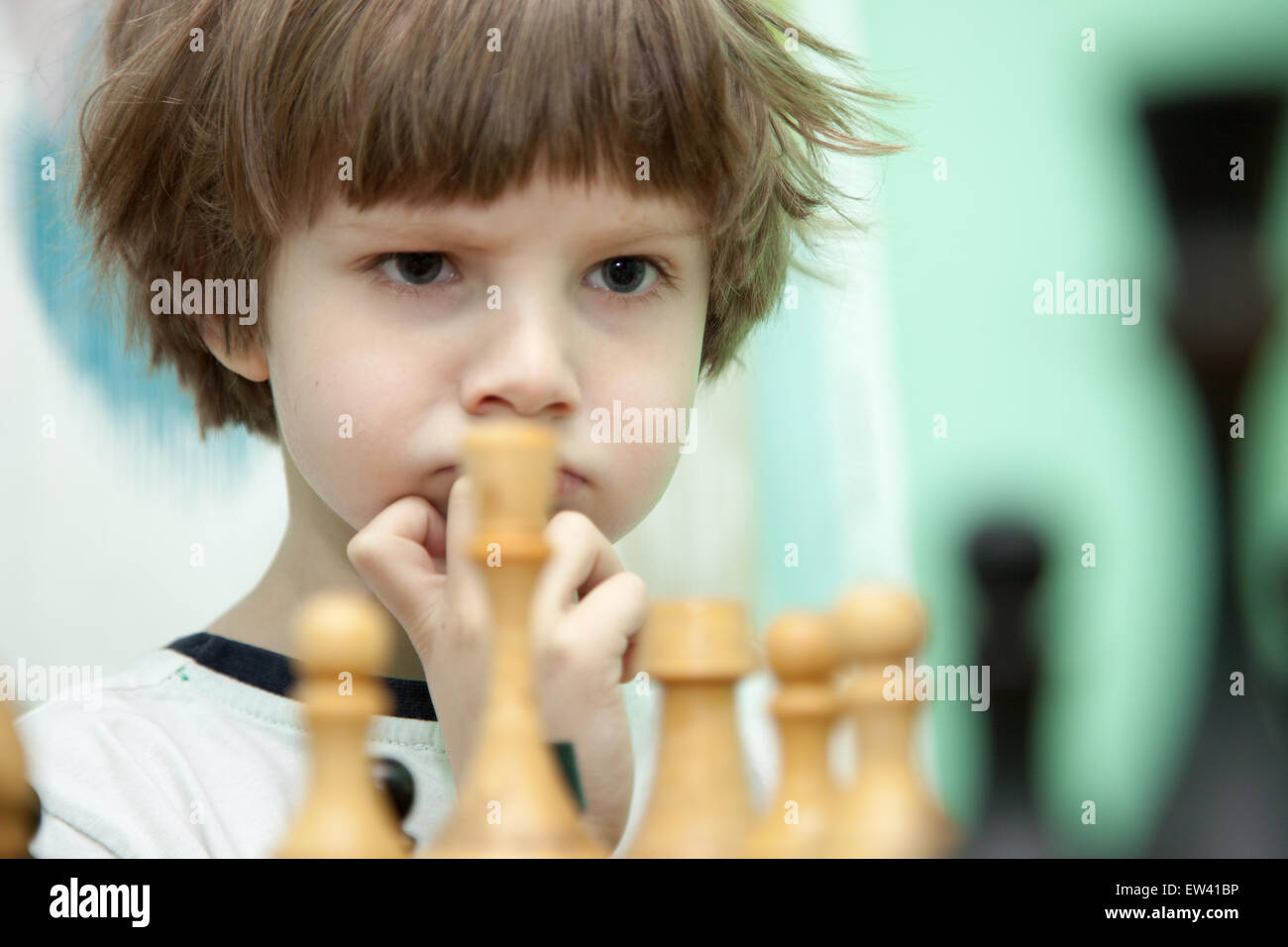 Portrait of a little boy playing chess Stock Photo - Alamy