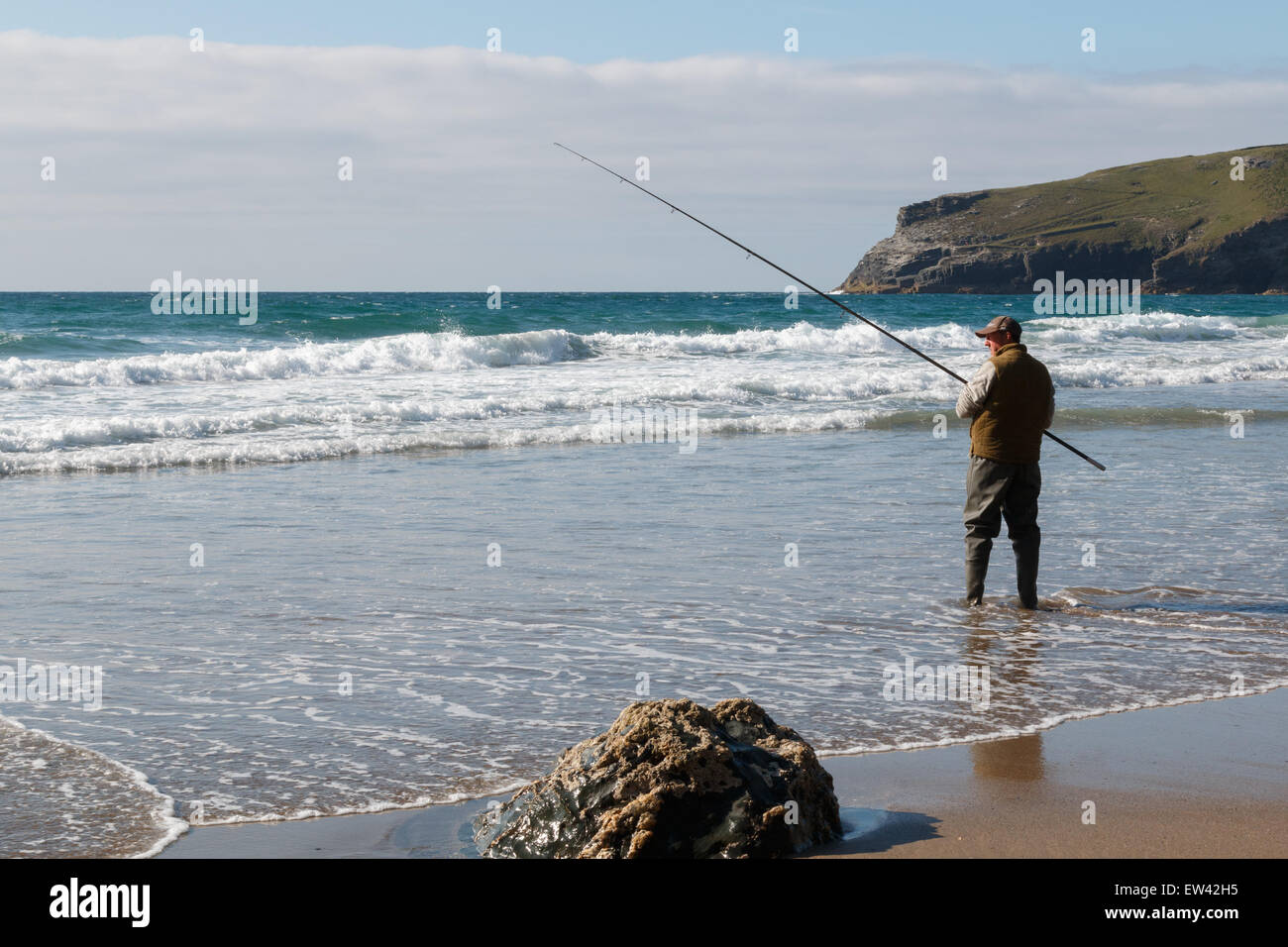 Fisherman sea fishing. A man standing on the beach fishing on the ...