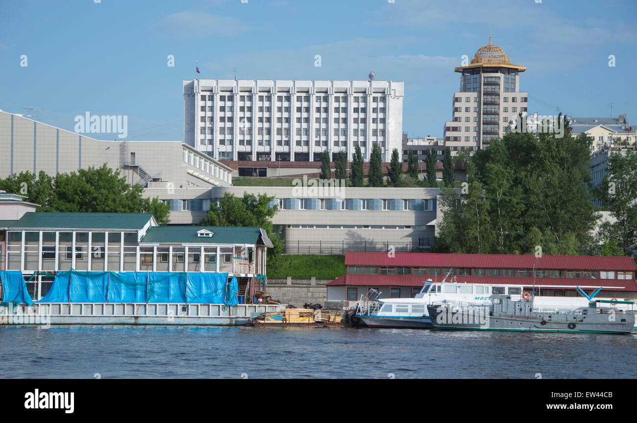 blue dock on the river and the trees and the temple in the background ...