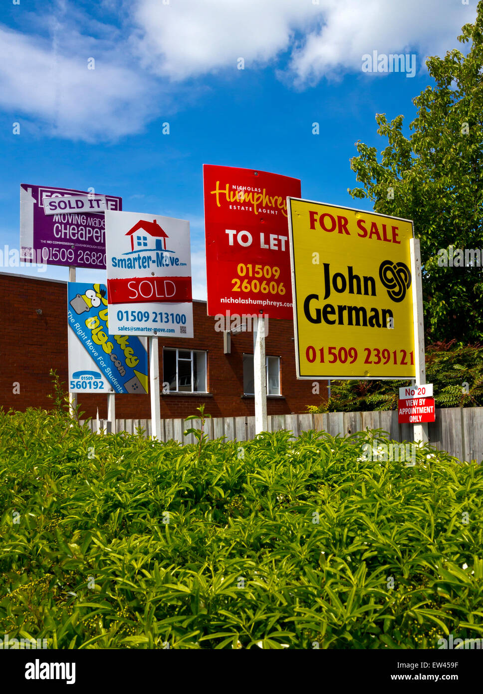 Brightly coloured For Sale To Let and Sold signs on a street in ...