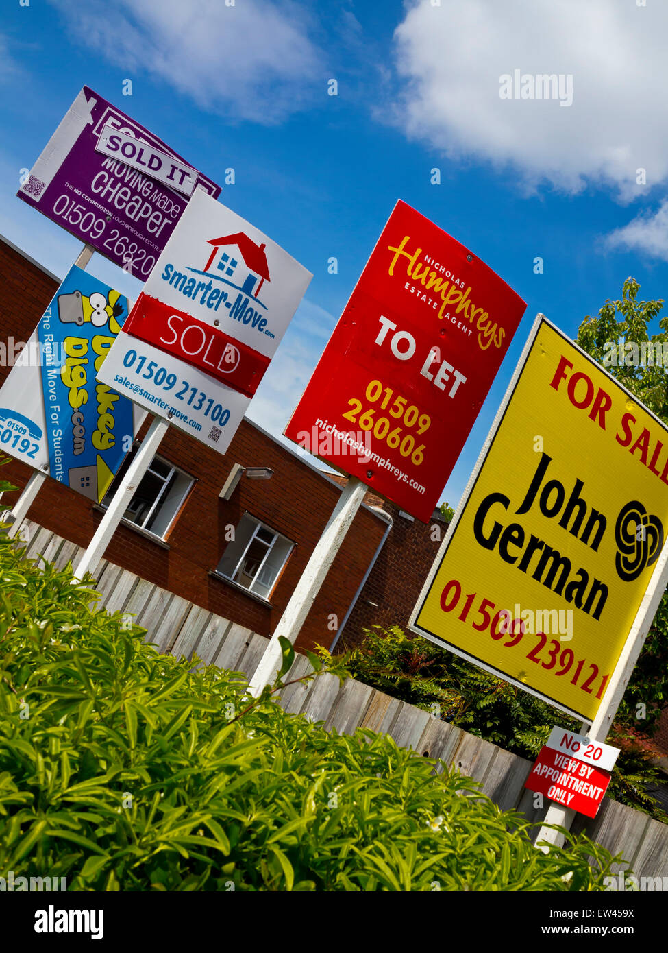 Brightly coloured For Sale To Let and Sold signs on a street in ...