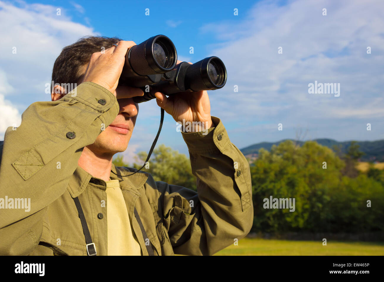 Man with binoculars Stock Photo - Alamy