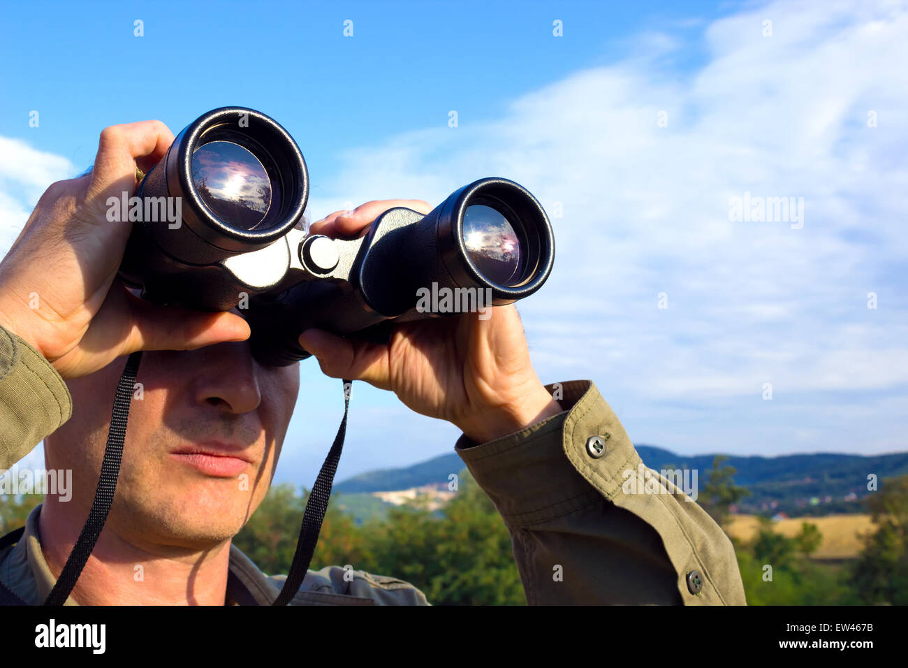 Man with binoculars Stock Photo - Alamy