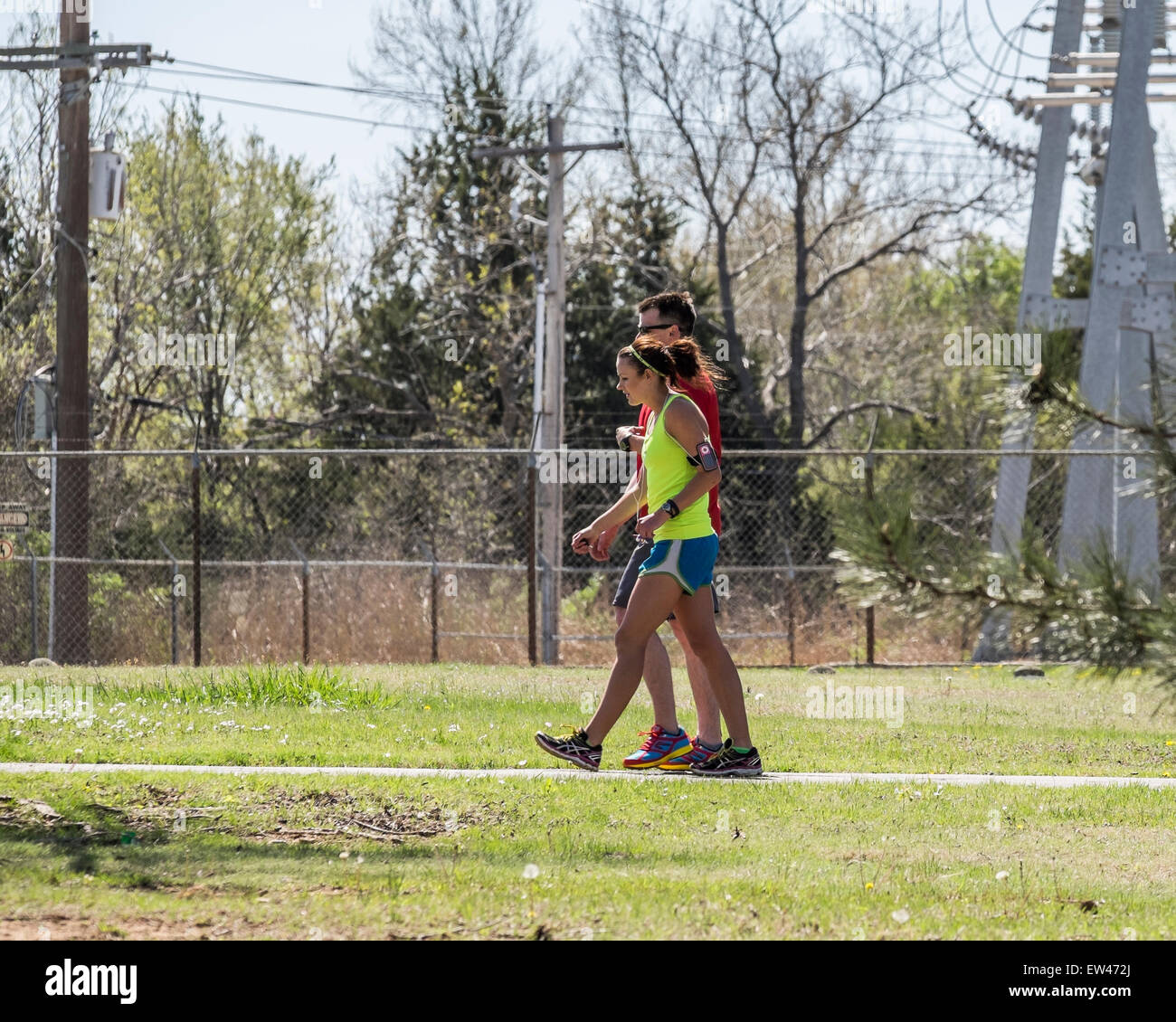 A young Caucasian couple in exercise clothes, the woman with a step ...