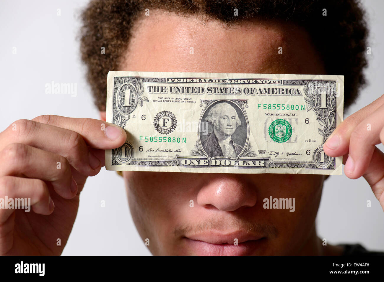 A young man with a one dollar bill Stock Photo - Alamy
